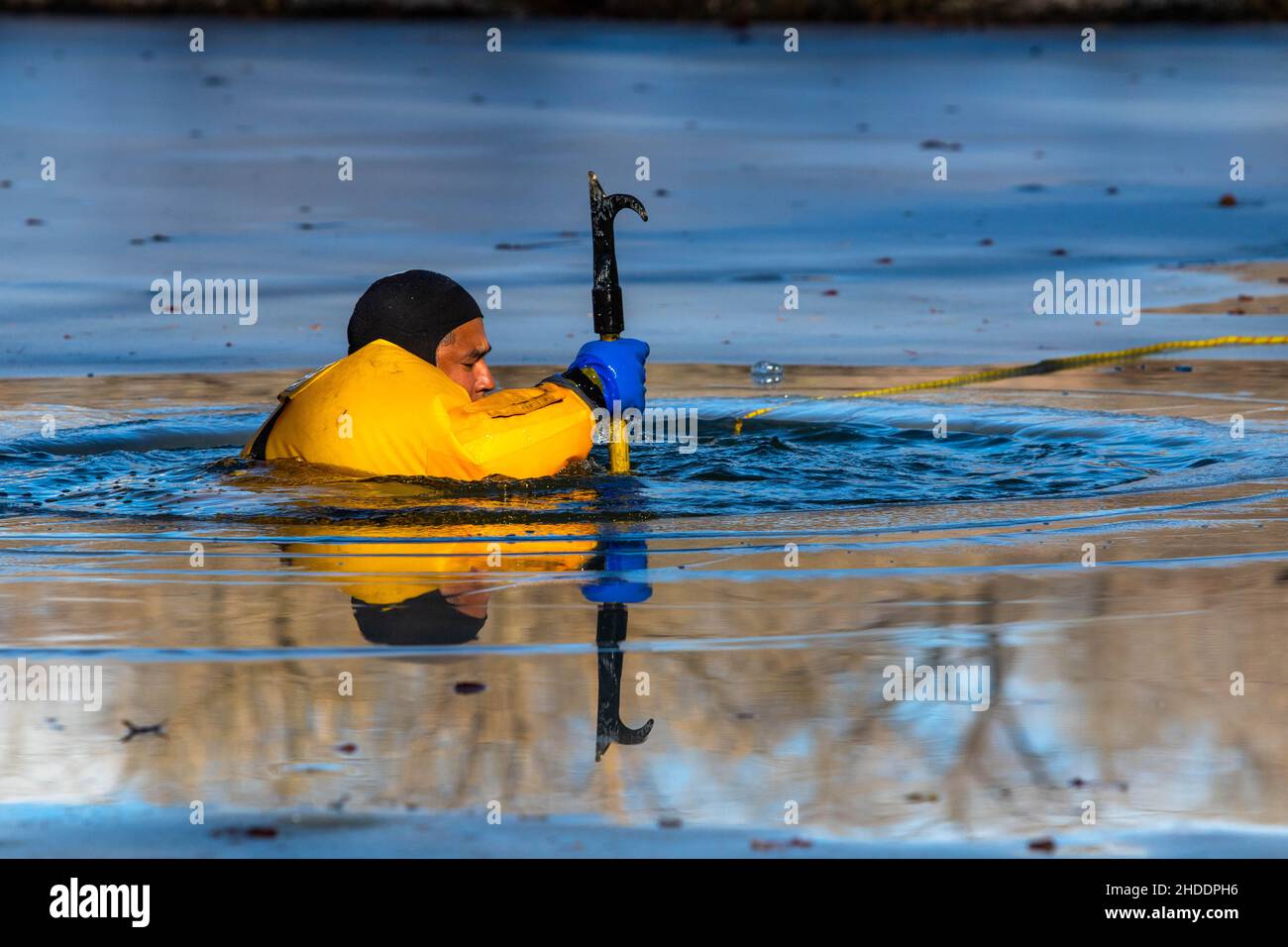 A rescuer prods the bottom of a frozen pond during the training.The ...