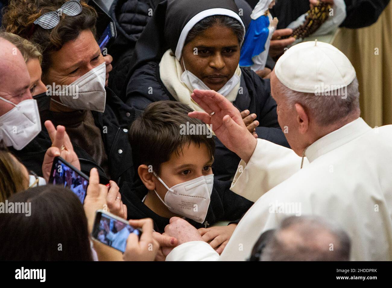 Pope Francis seen blessing a faithful kid, during the Paul VI General ...