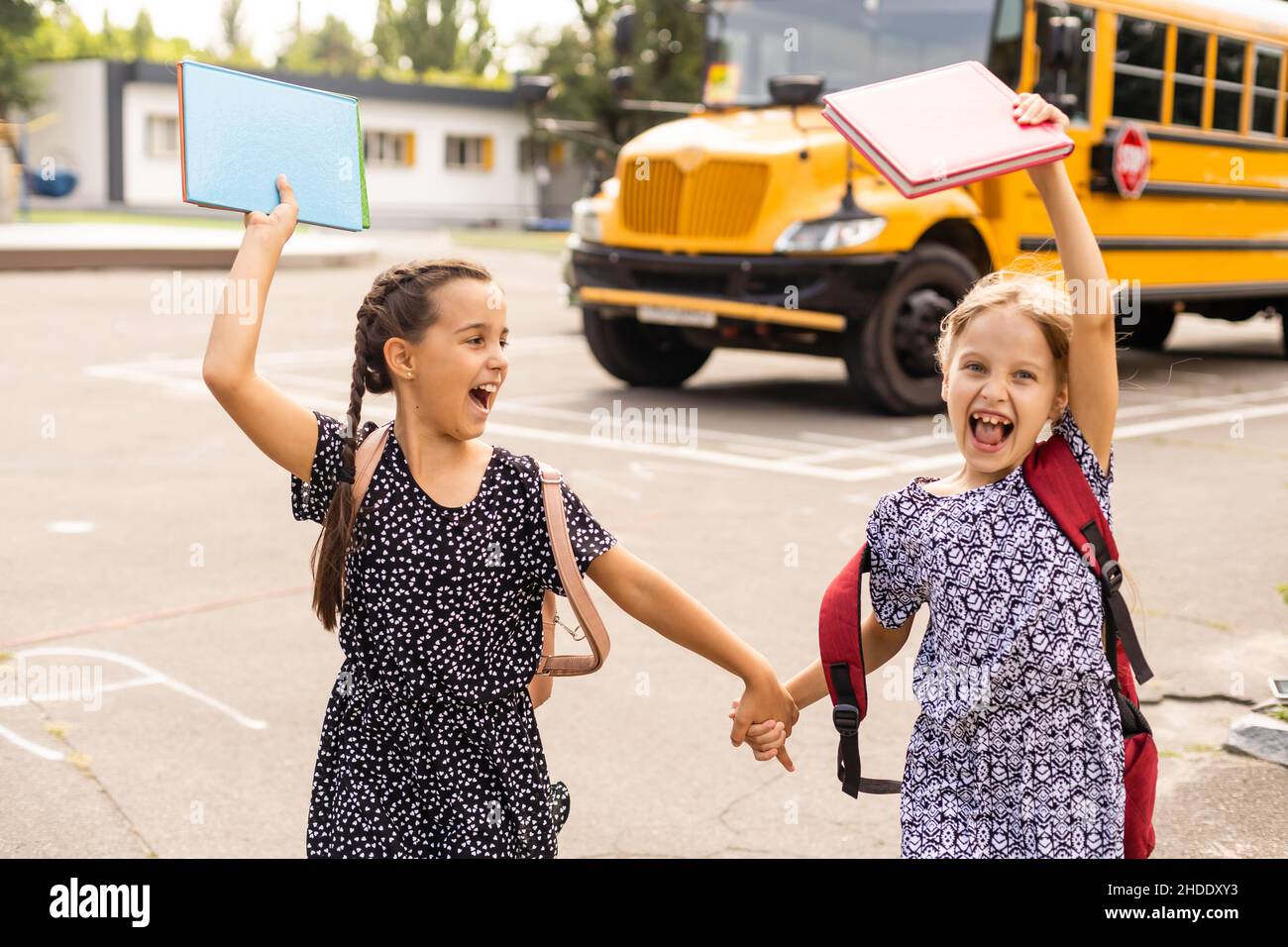 Education: Smiling Student Friends Ready For School next to school bus ...