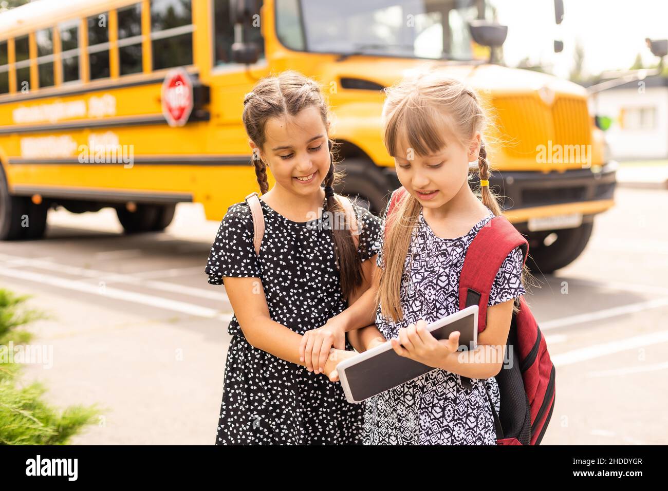 Education: Smiling Student Friends Ready For School next to school bus ...