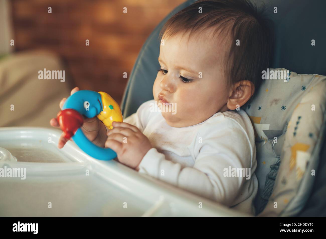 Caucasian newborn baby playing with colorful educational rattle toy ...