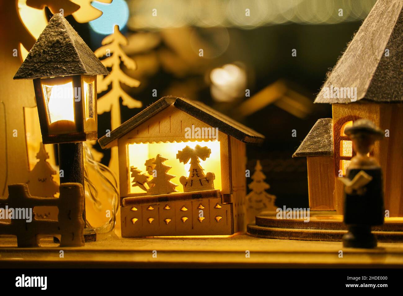 Close up shot of small wooden led light up house in a Christmas scene ...