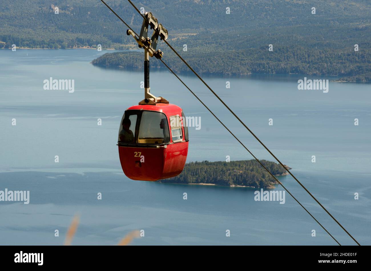 cable car with red cabins with panoramic views of the lake and ...