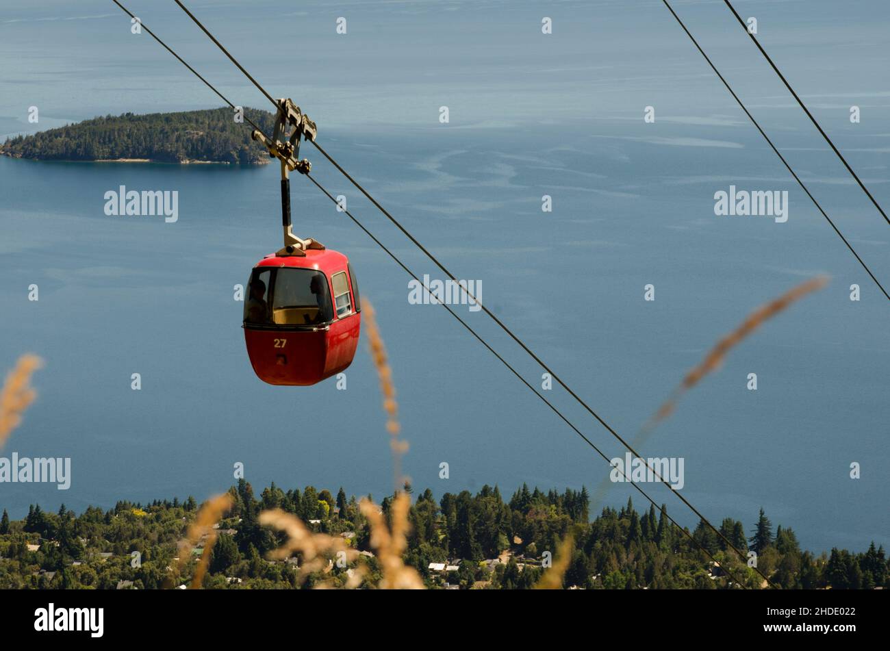 cable car with red cabins with panoramic views of the lake and ...