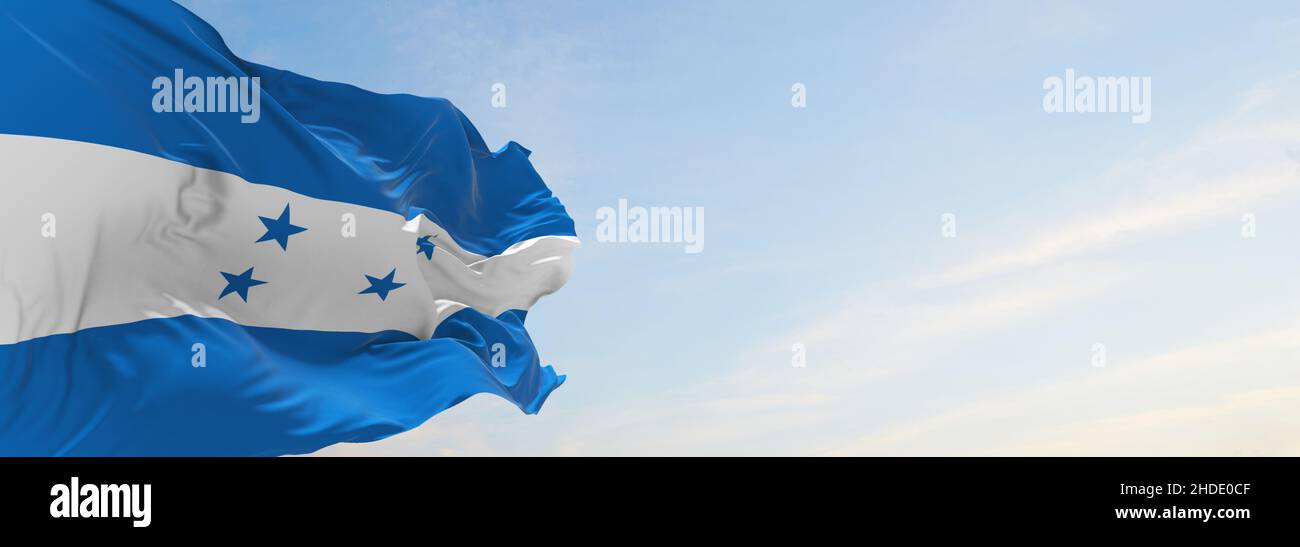 official flag of Honduras at cloudy sky background on sunset, panoramic ...