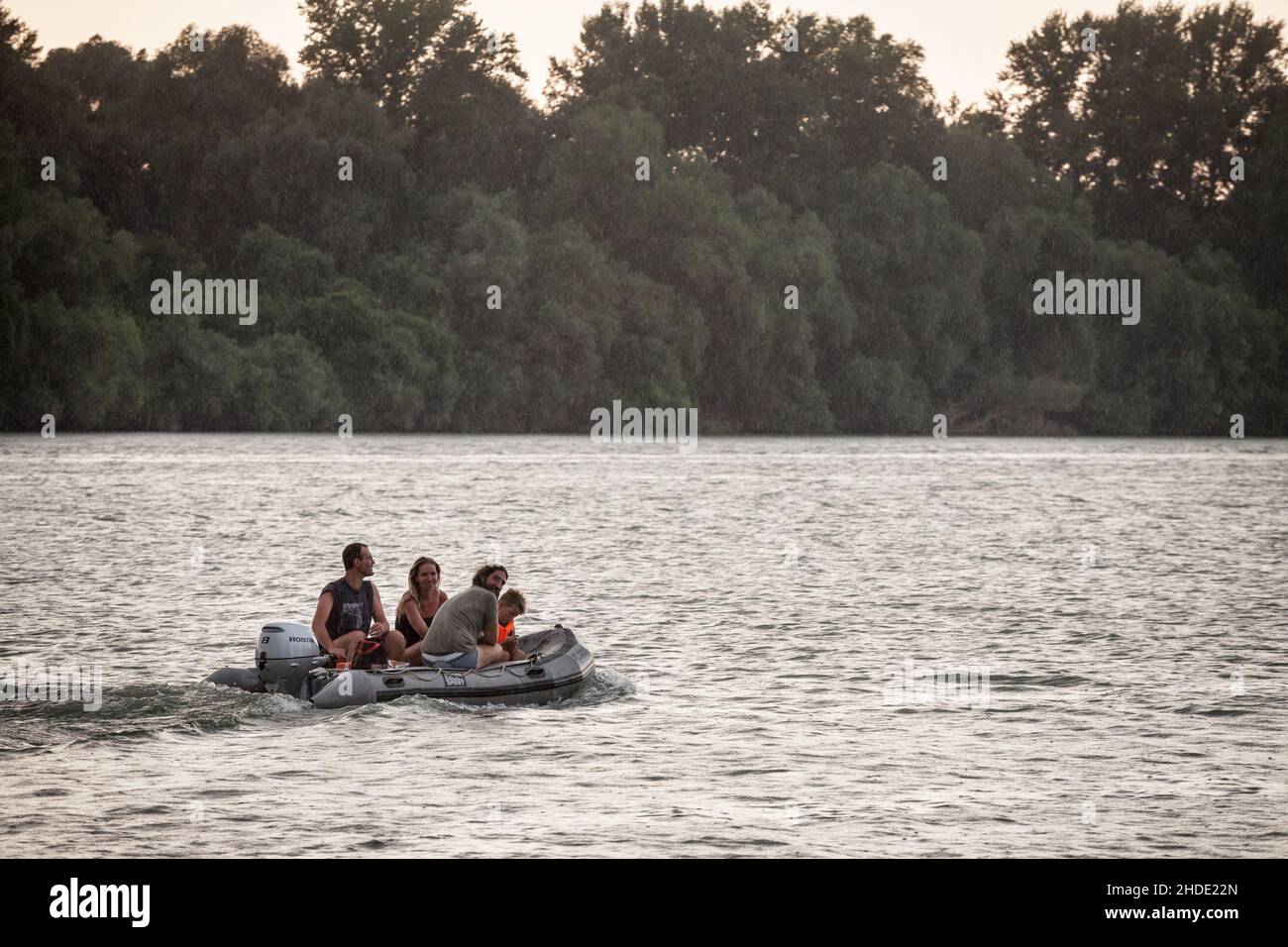 Picture of a crowd of persons riding an inflatable boat on the river ...
