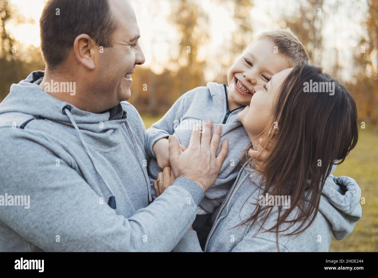 Family of three members having fun together outdoor. Walking in park ...