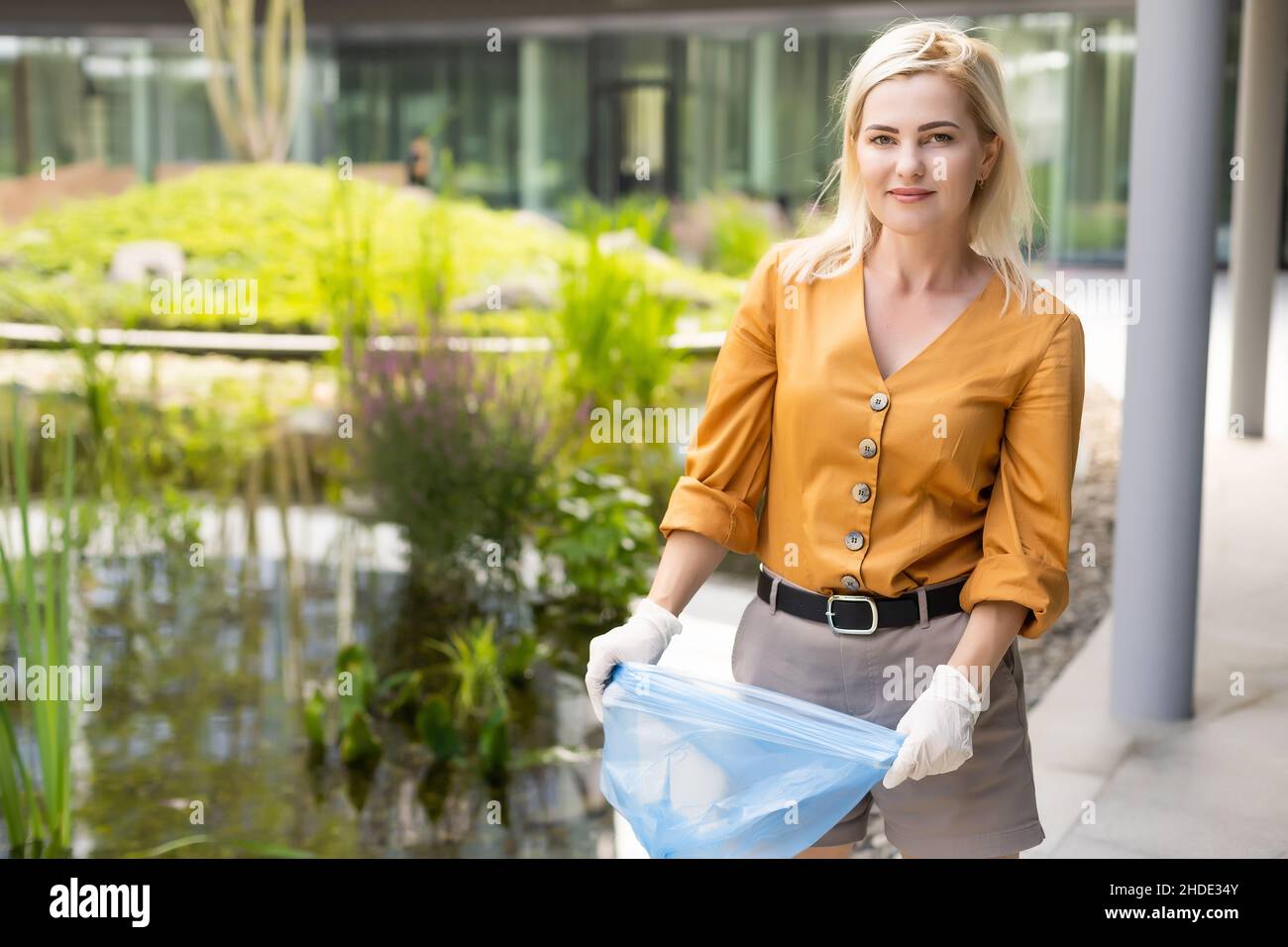 woman picking up trash outdoors in the street in summer Stock Photo - Alamy