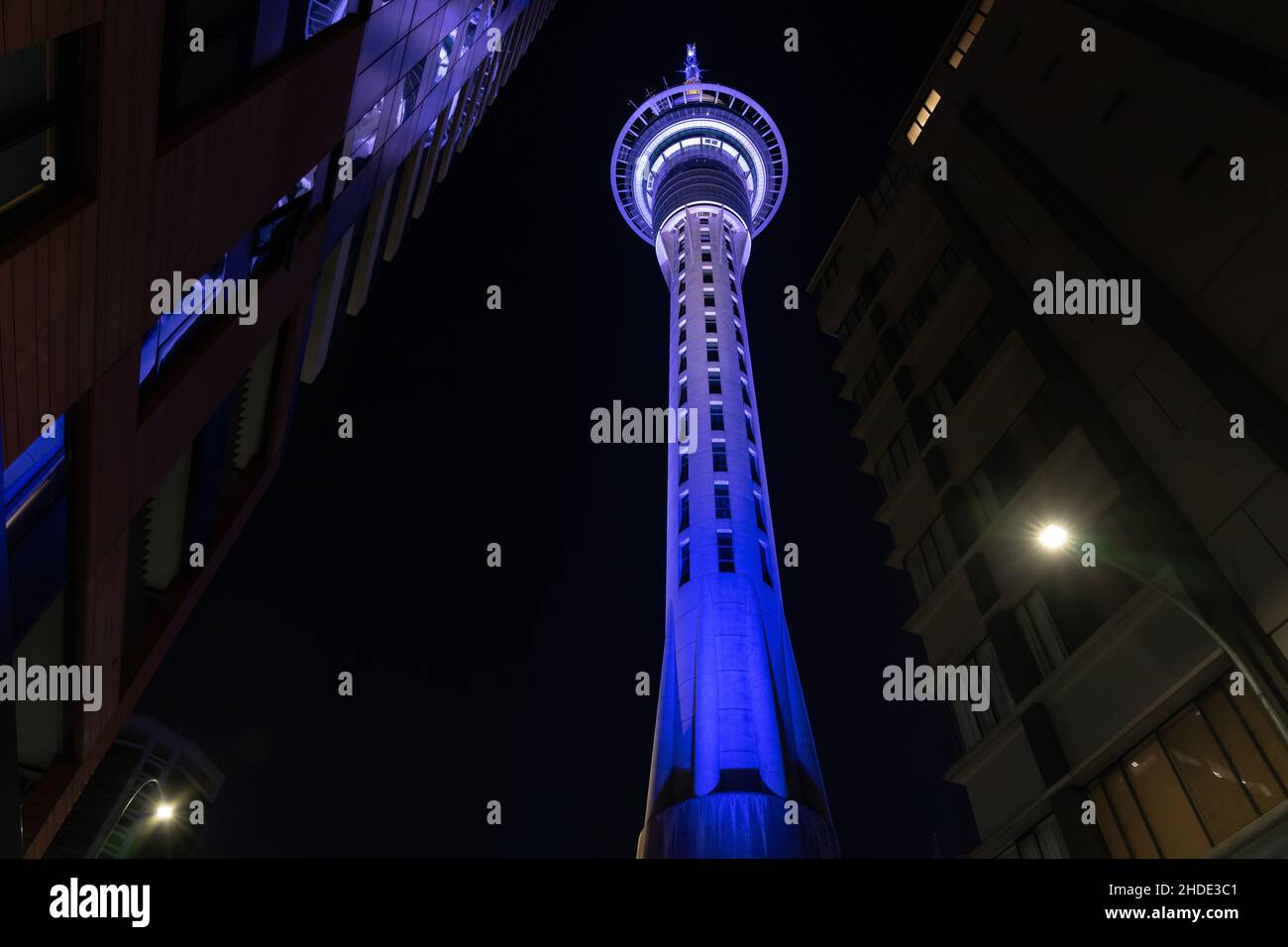 NIght scene tall circular tower illuminated blue Stock Photo - Alamy