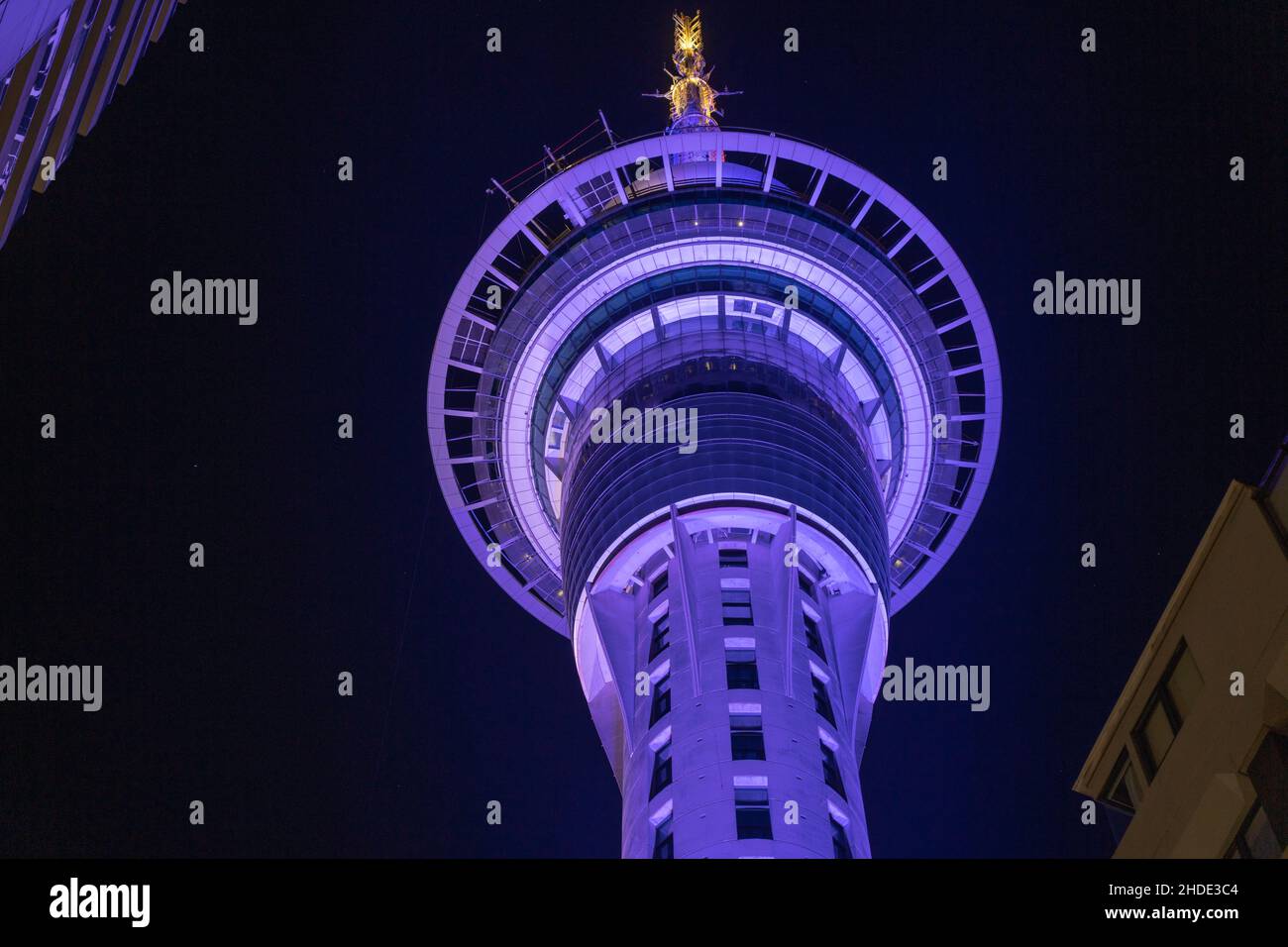 NIght scene tall circular tower illuminated blue Stock Photo - Alamy