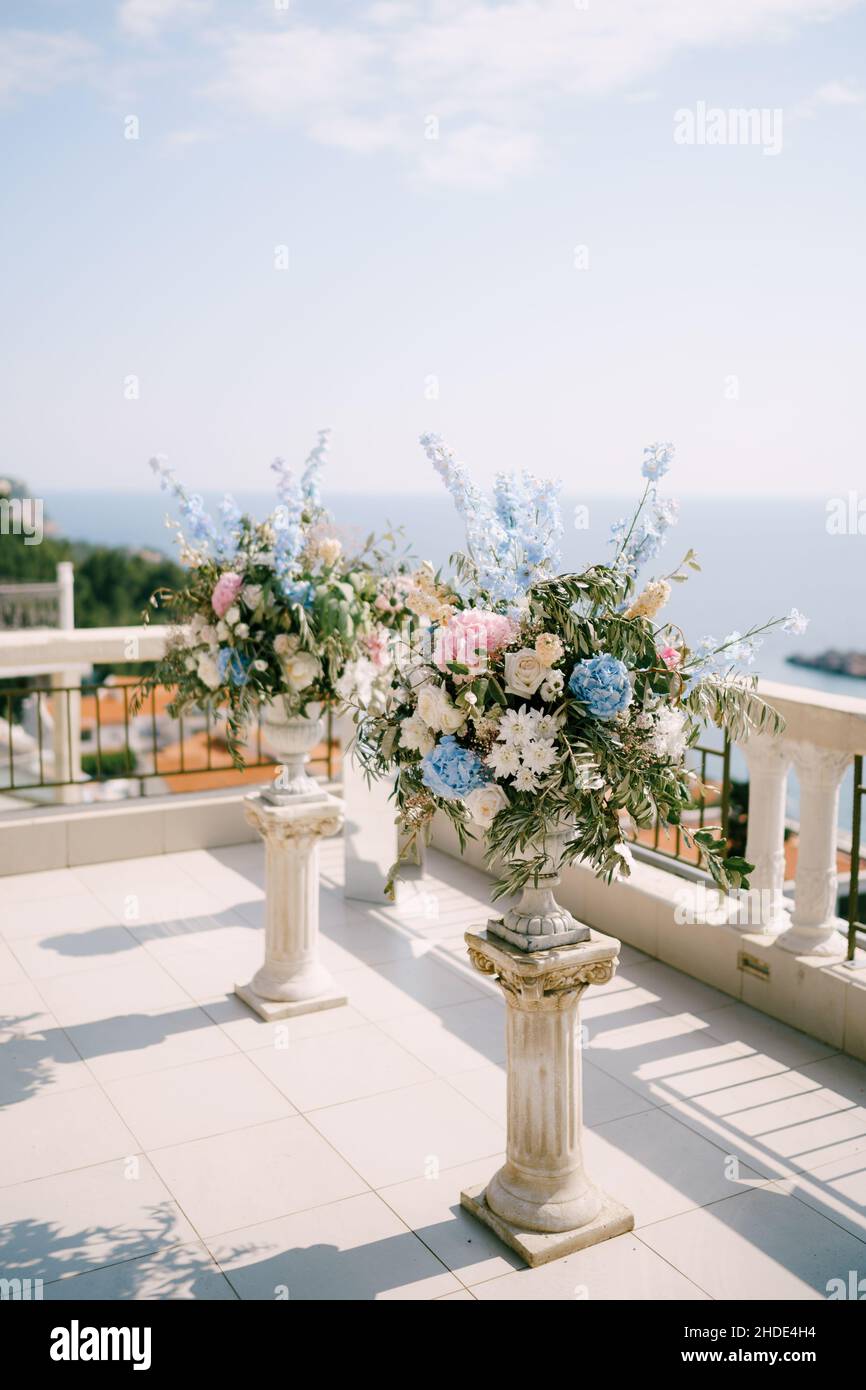 Bouquets of flowers stand on a terrace overlooking the sea Stock Photo ...