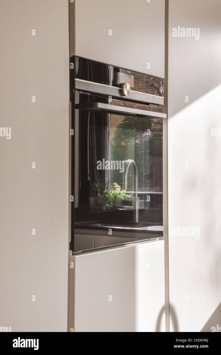 Modern oven built into the kitchen unit in a chic kitchen Stock Photo ...