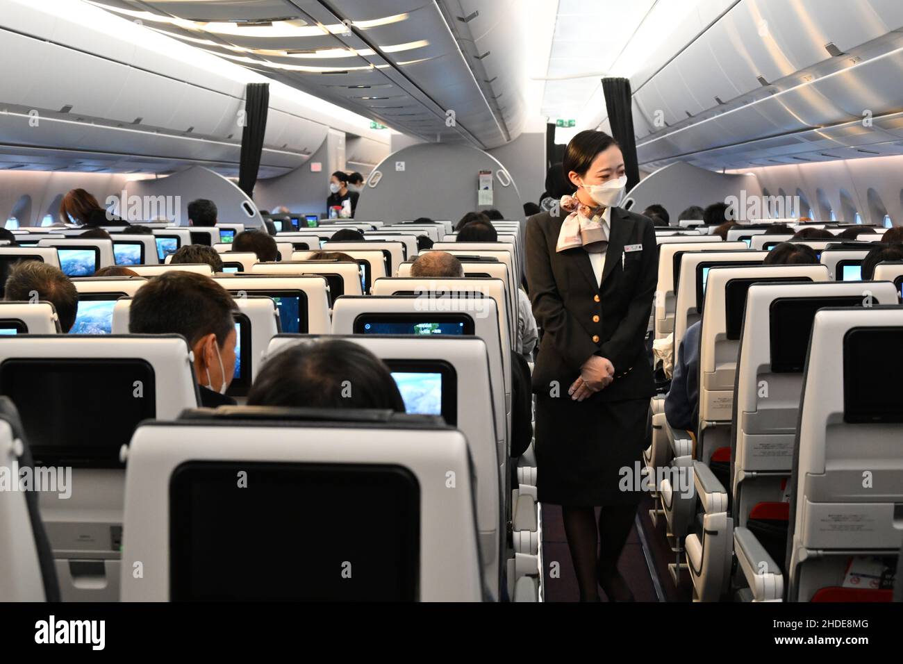A JAL flight attendant wearing the 9th generation uniform going her ...