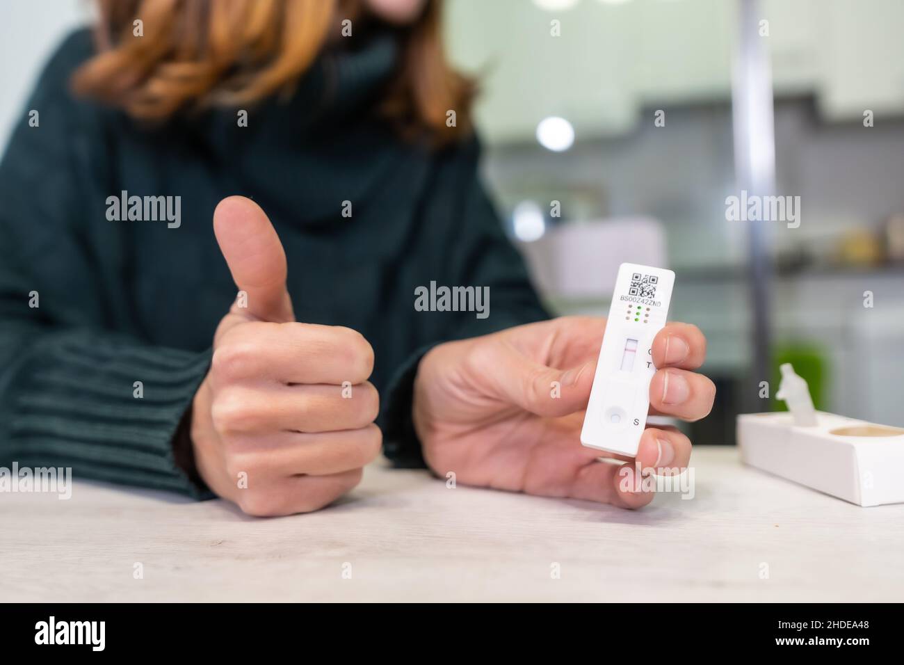Happy with the negative test result. A young woman doing the rapid ...