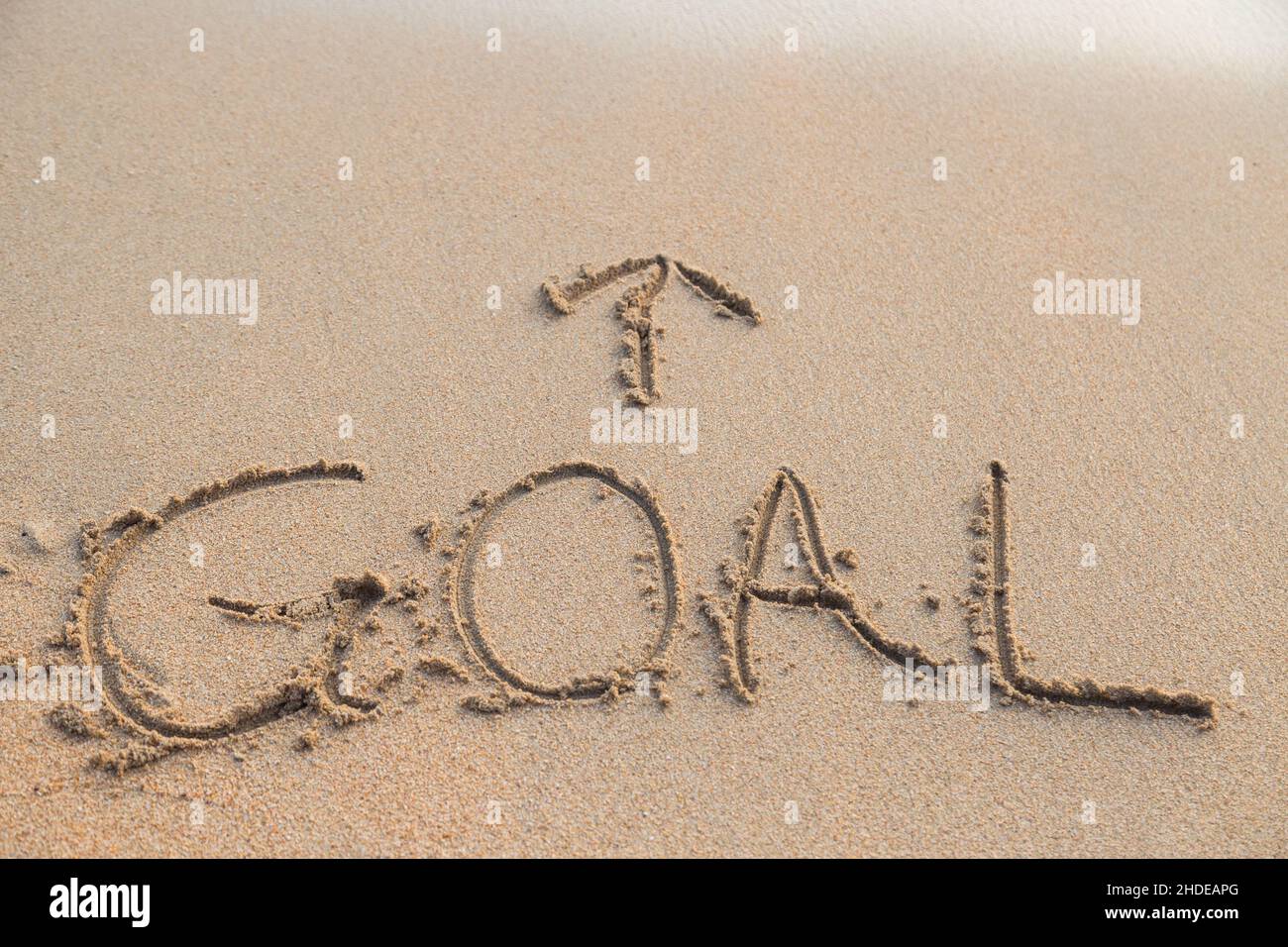 Message goal on the sand with upper arrow on sand at the beach ...