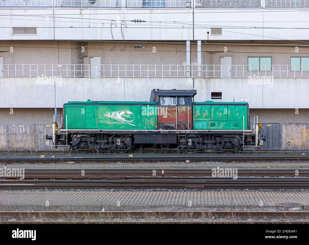 View of a vintage green wagon on a metal railway under a light building ...