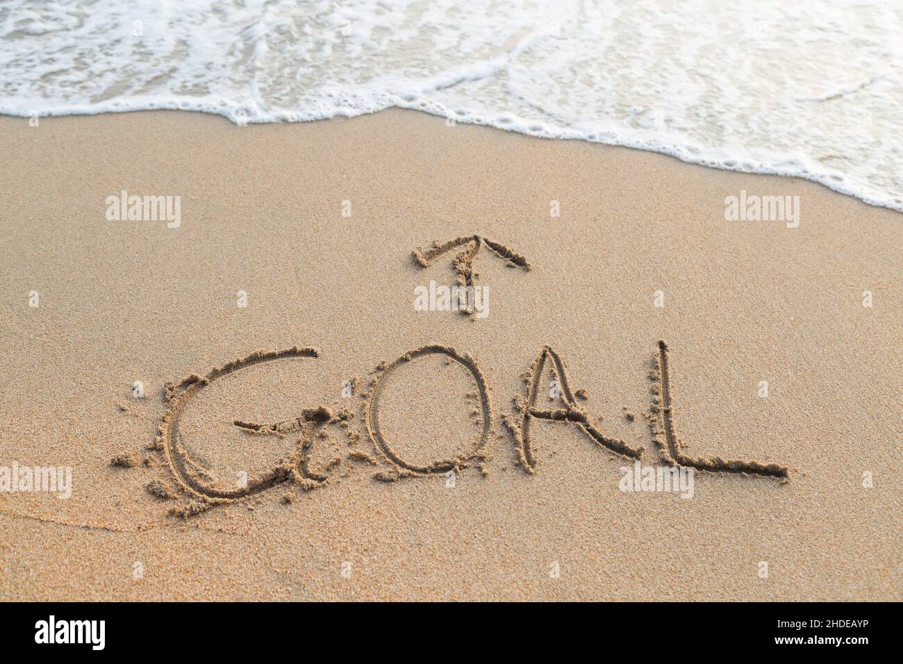 Message goal on the sand with upper arrow on sand at the beach ...