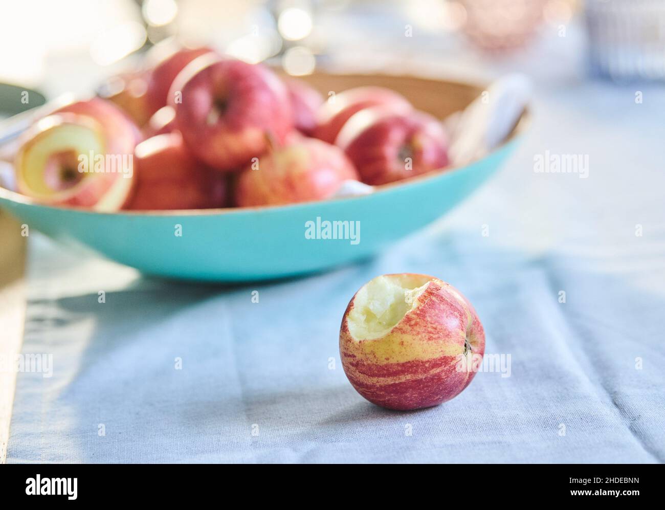 Berlin, Germany. 03rd Jan, 2022. A bitten apple lies in front of a bowl ...