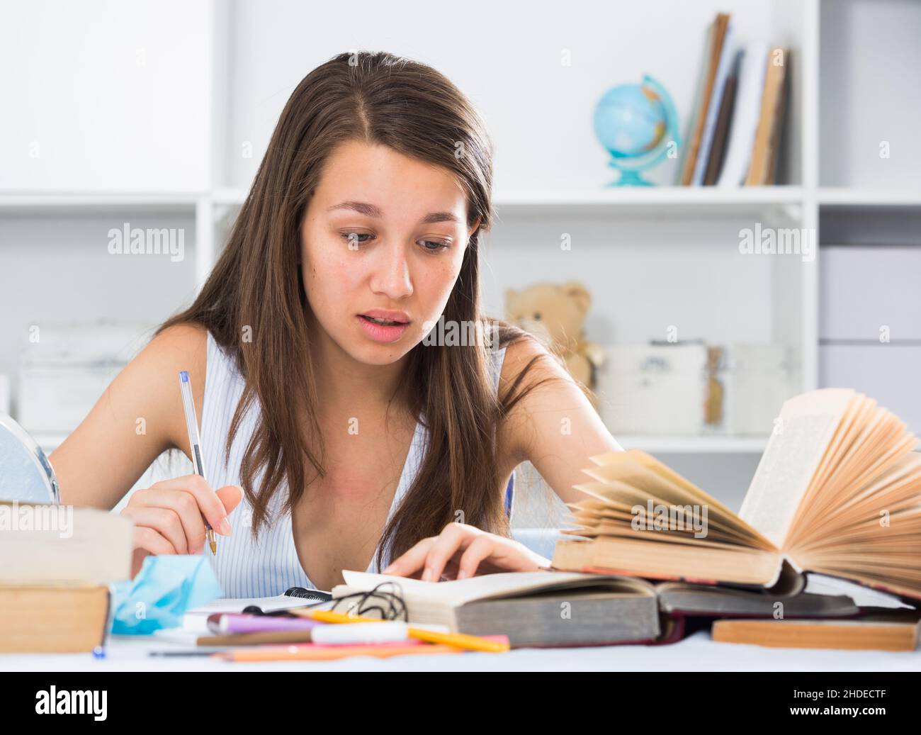 Teenage female is writing a review of novel Stock Photo - Alamy