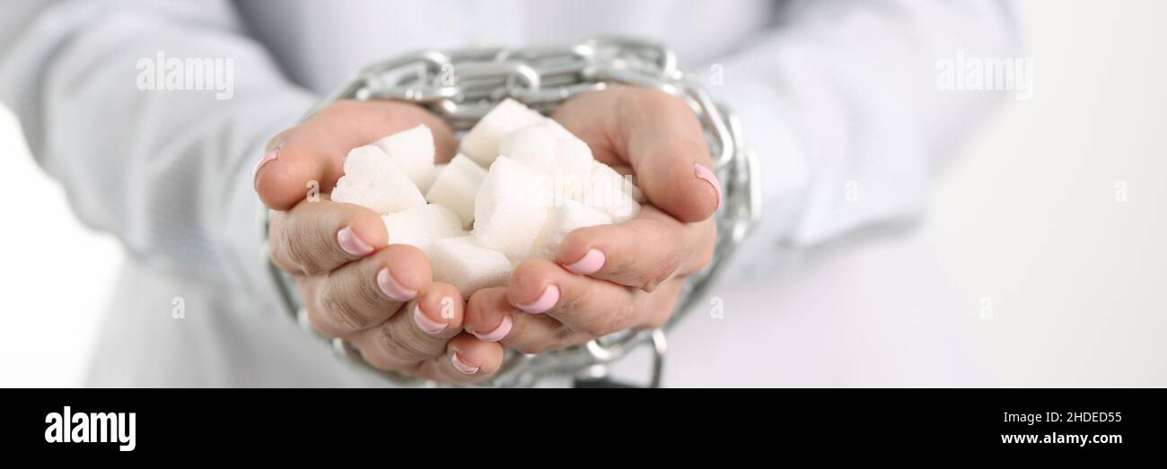 Female tied hands with hold white lump sugar chain closeup Stock Photo ...