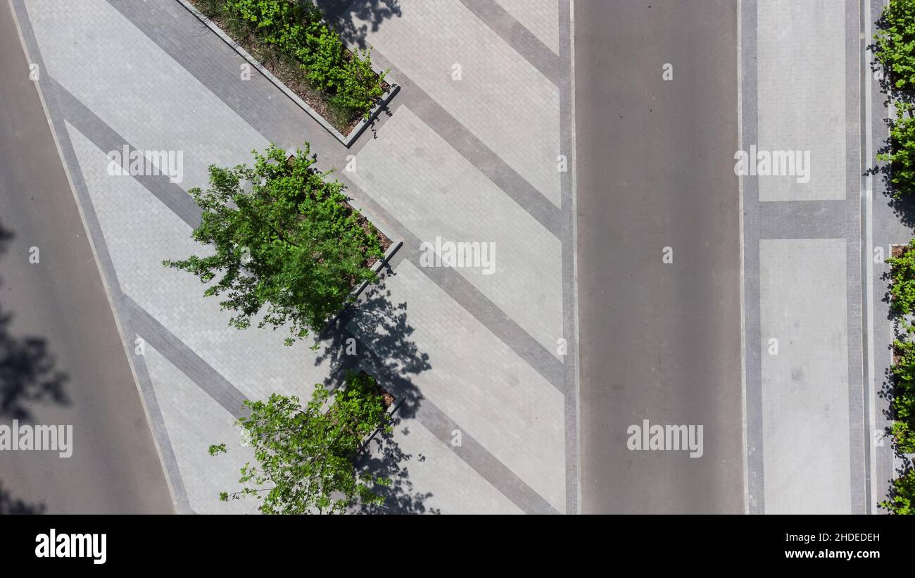 aerial top view of street with parking lot near new residential housing ...