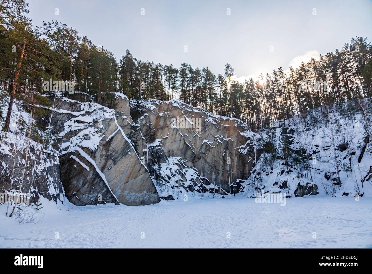 Sheer cliffs and rocks around the Talc quarry in winter in Russia in ...