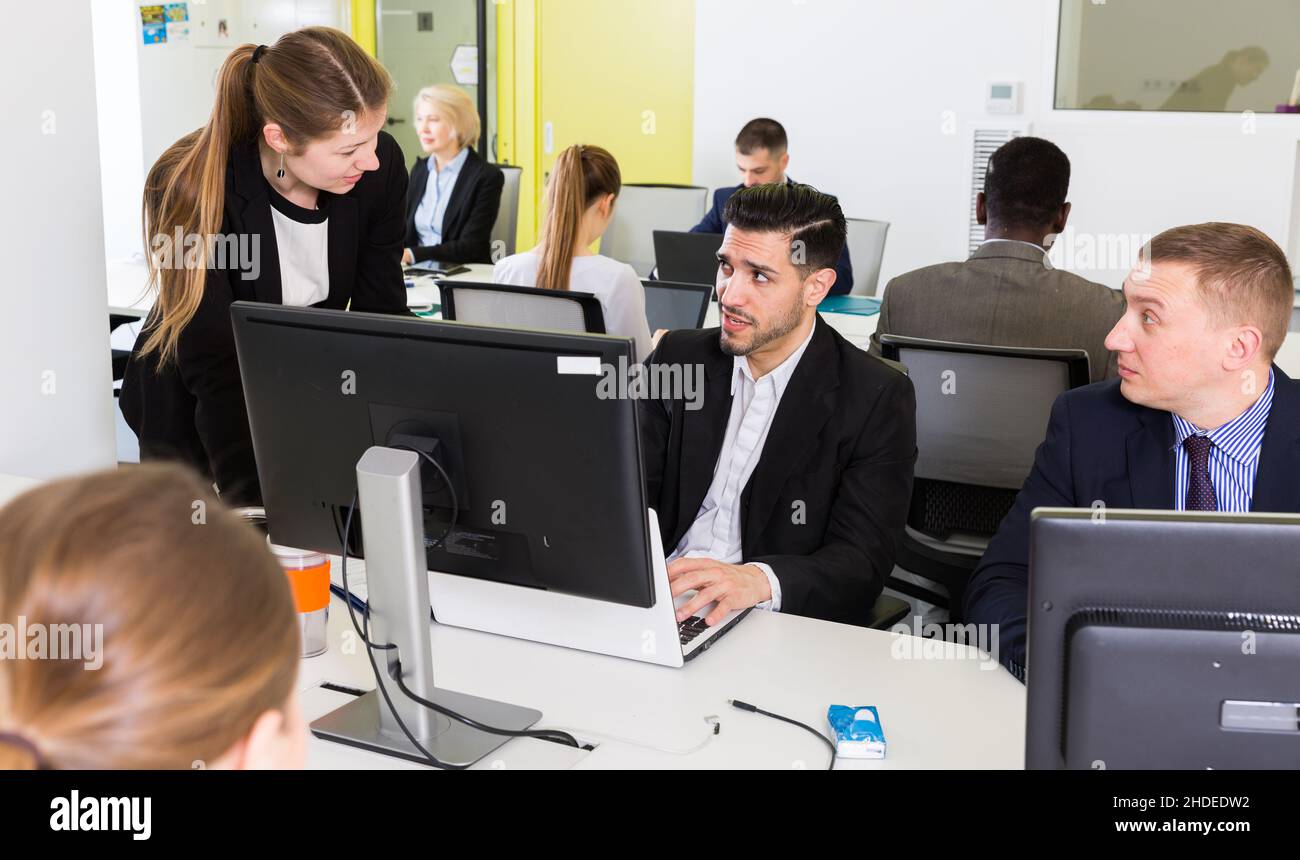 Business people working in open plan office Stock Photo - Alamy