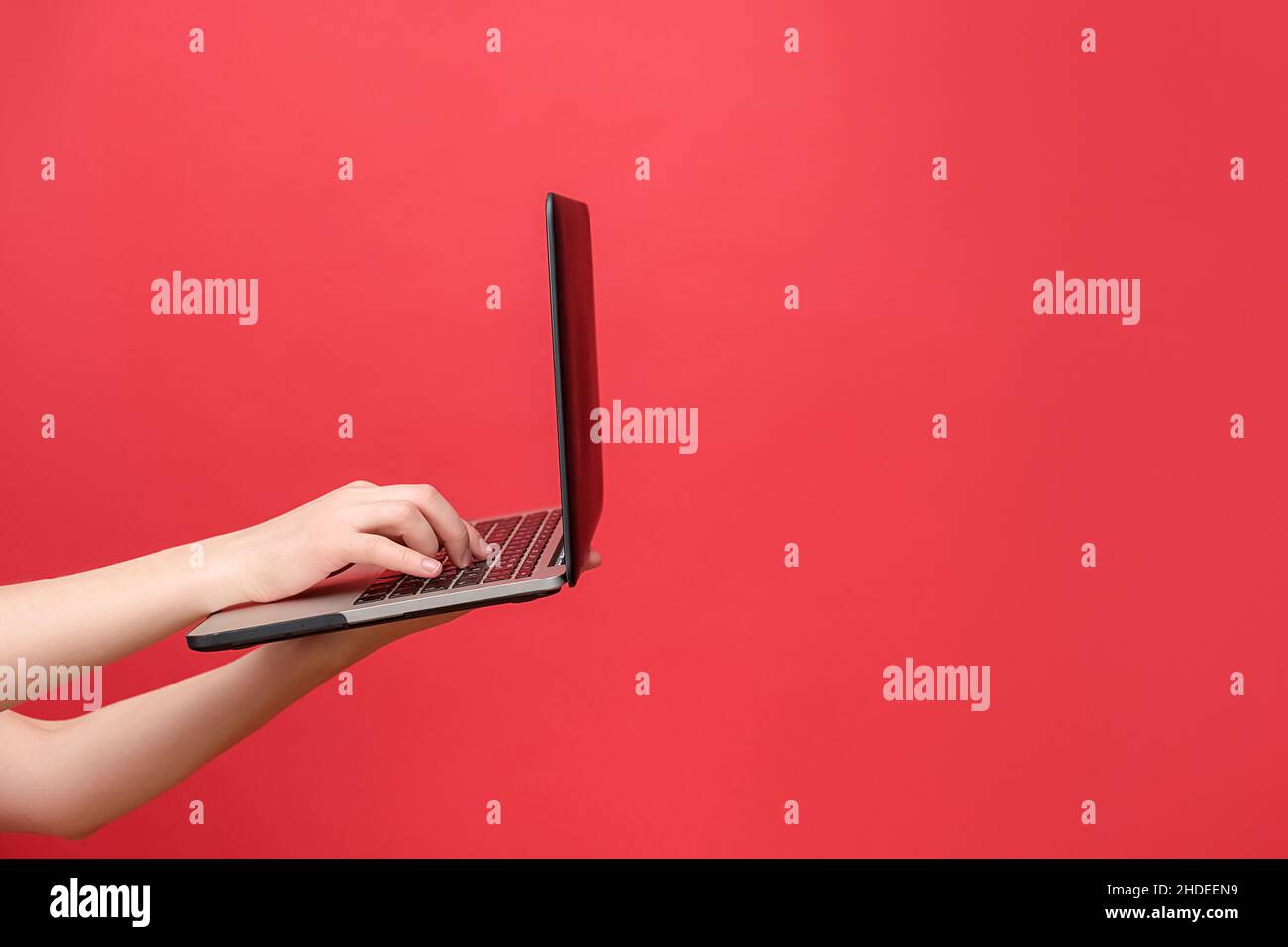 Close up of female hand holding working on laptop pc computer typing on ...
