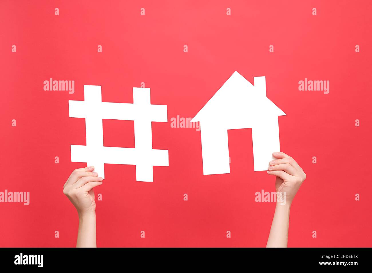 Female hands holding yellow hashtag sign and house model, label for ...