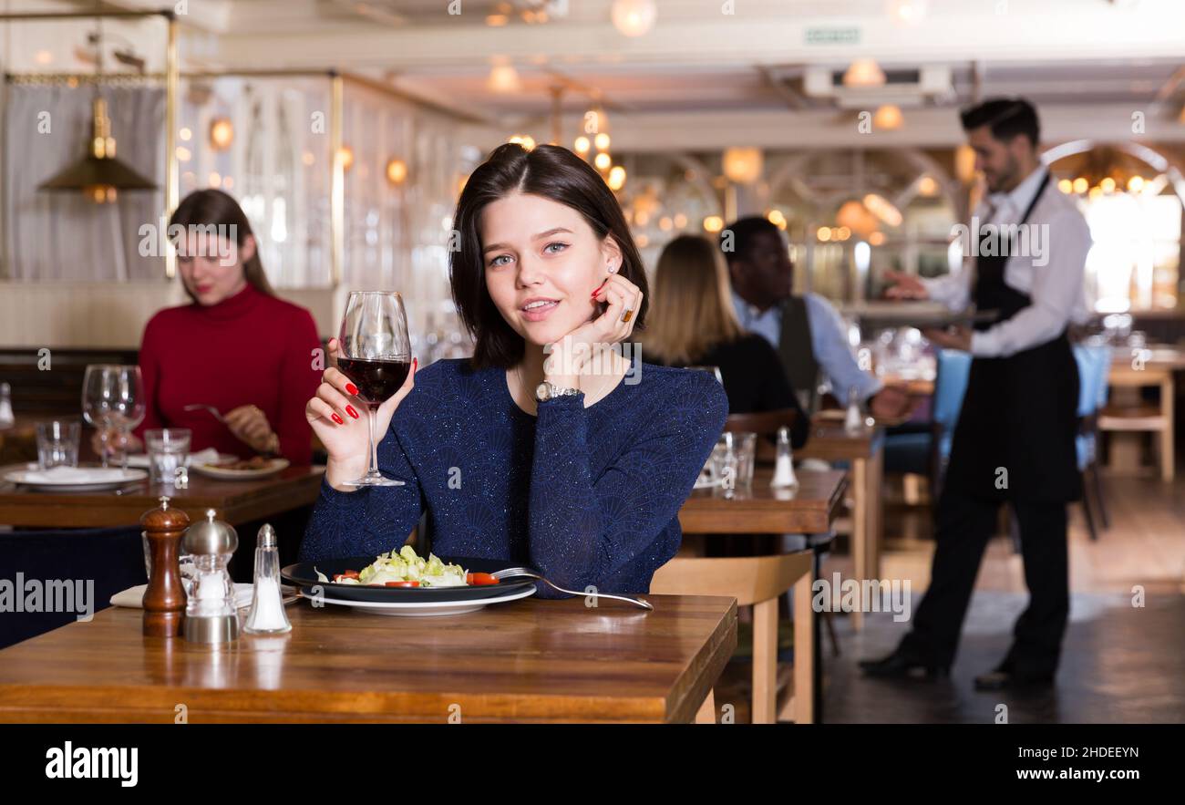 Woman enjoying dinner alone in restaurant Stock Photo - Alamy
