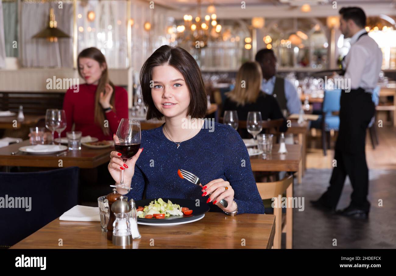 Woman enjoying dinner alone in restaurant Stock Photo - Alamy