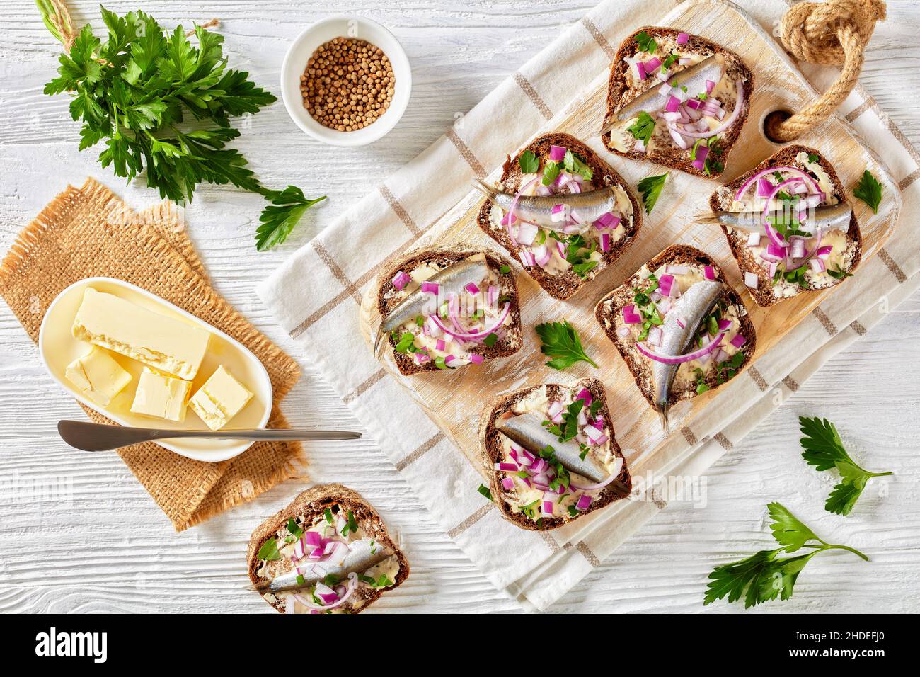 pickled sprat open sandwiches with butter and red onion on rye bread ...
