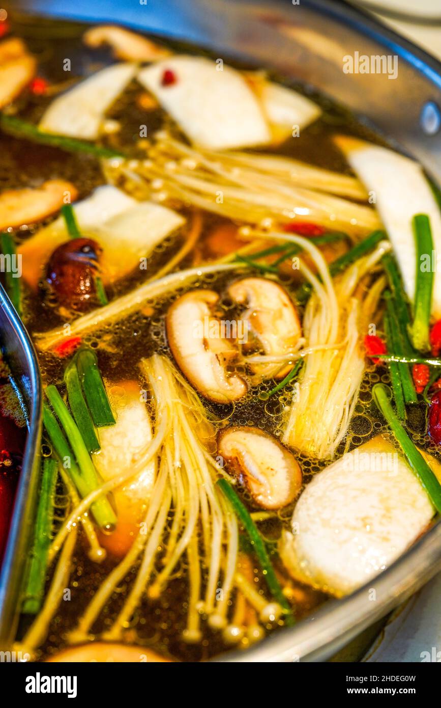 Close-up of the bottom of traditional Chinese Sichuan hot pot, two ...