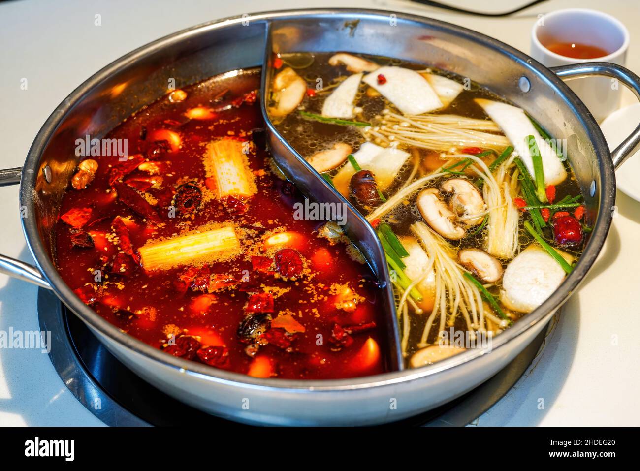 Close-up of the bottom of traditional Chinese Sichuan hot pot, two flavors Stock Photo - Alamy