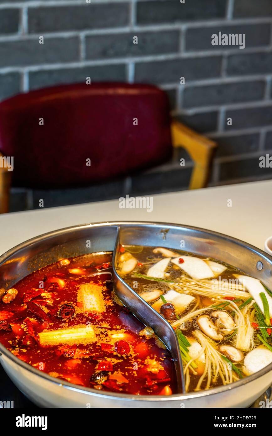 Close-up of the bottom of traditional Chinese Sichuan hot pot, two ...