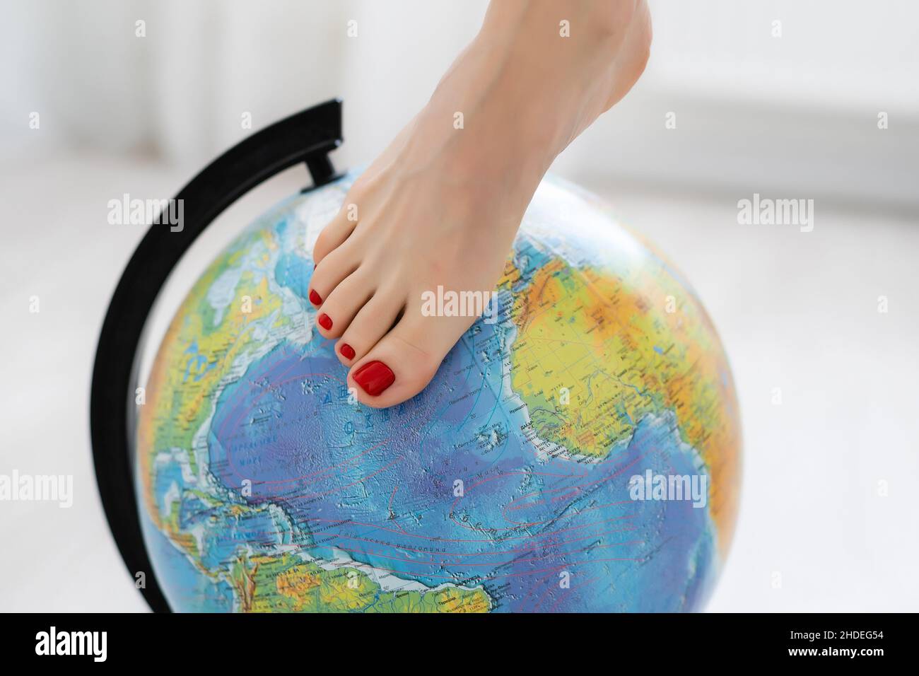 Geographical globe kick a womans foot Minimal global concept Stock ...