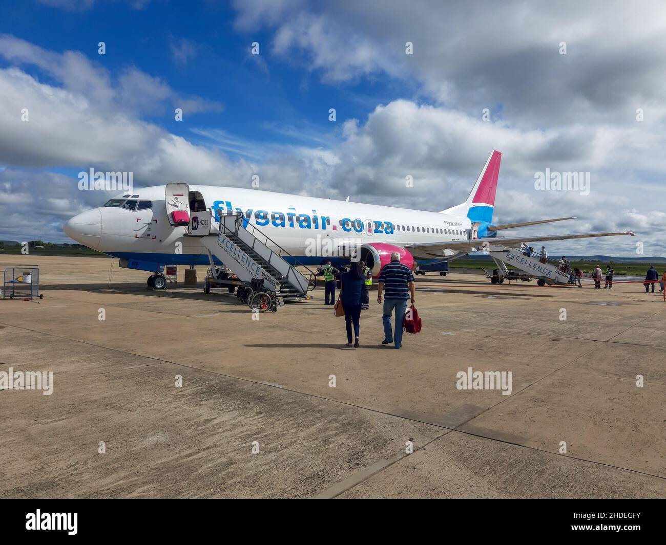 BLOEMFONTEIN, SOUTH AFRICA - DEC 23, 2021: People boarding a Boeing 737 ...