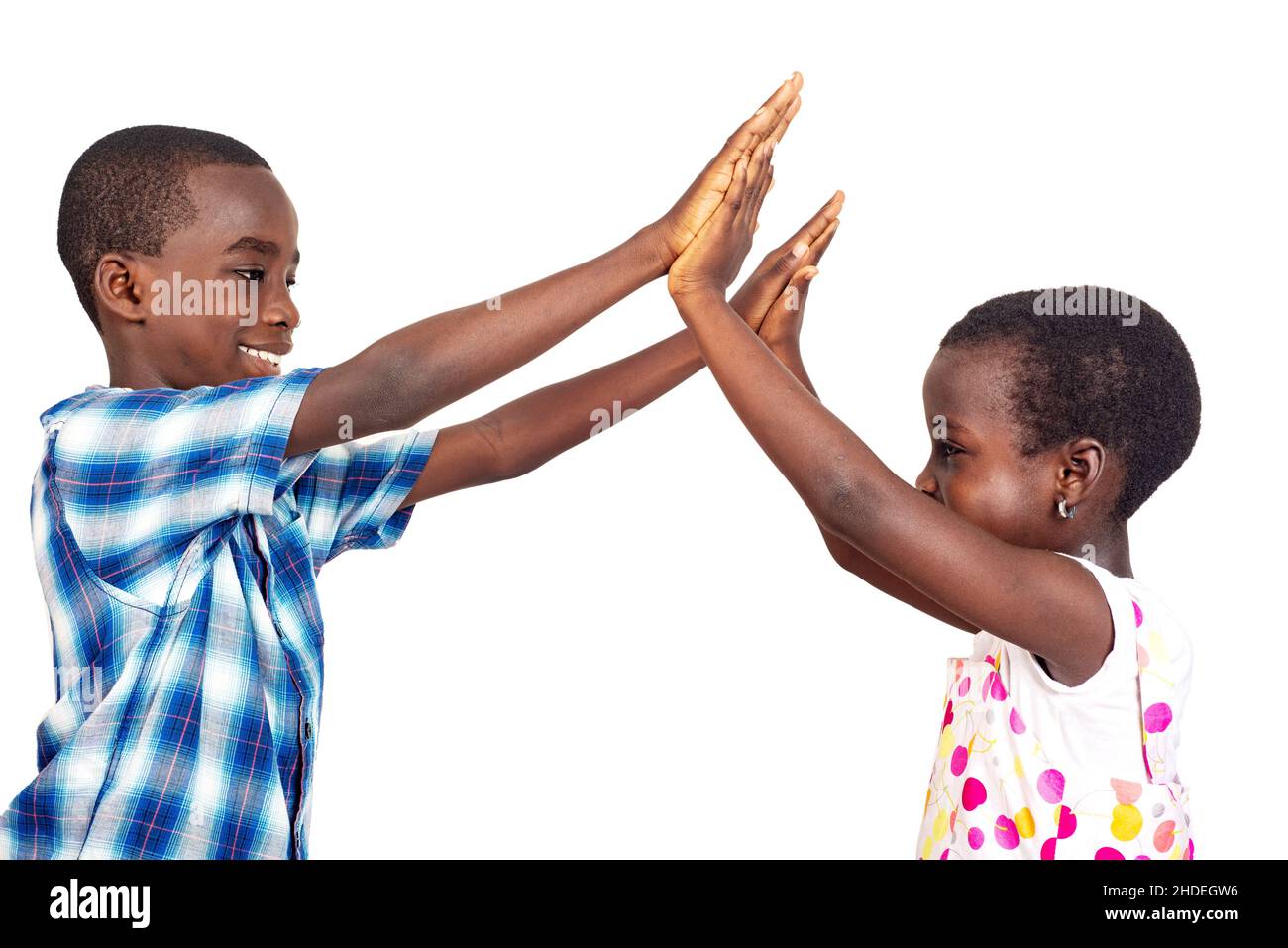two little children playing indoors with folded hands smiling Stock ...