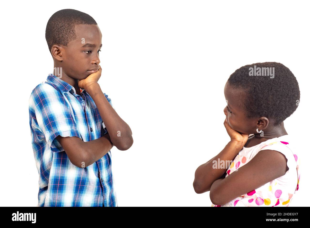 two cute little kids thinking and looking at each other with their ...