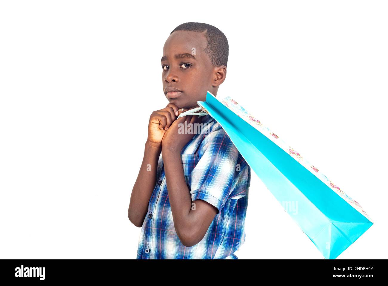 cute little boy standing aside and holding a shopping bag Stock Photo ...