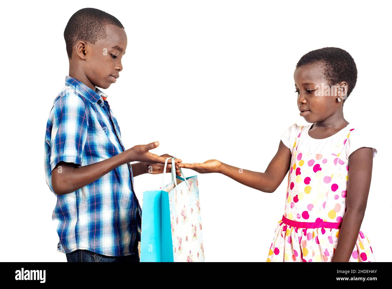 little boy giving shopping bag to a cute little girl Stock Photo - Alamy