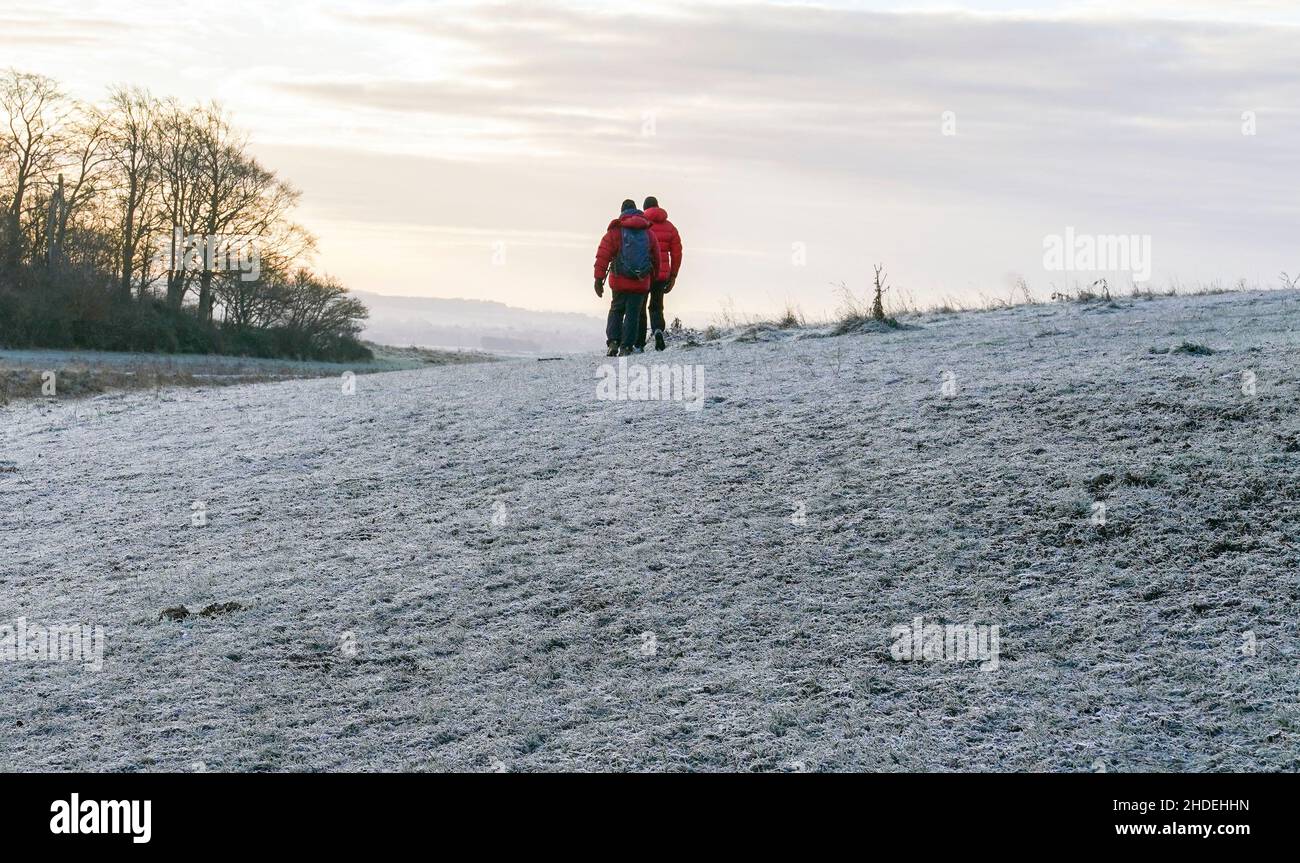 Walkers walk in the frost at Wittenham Clumps near Abingdon in ...