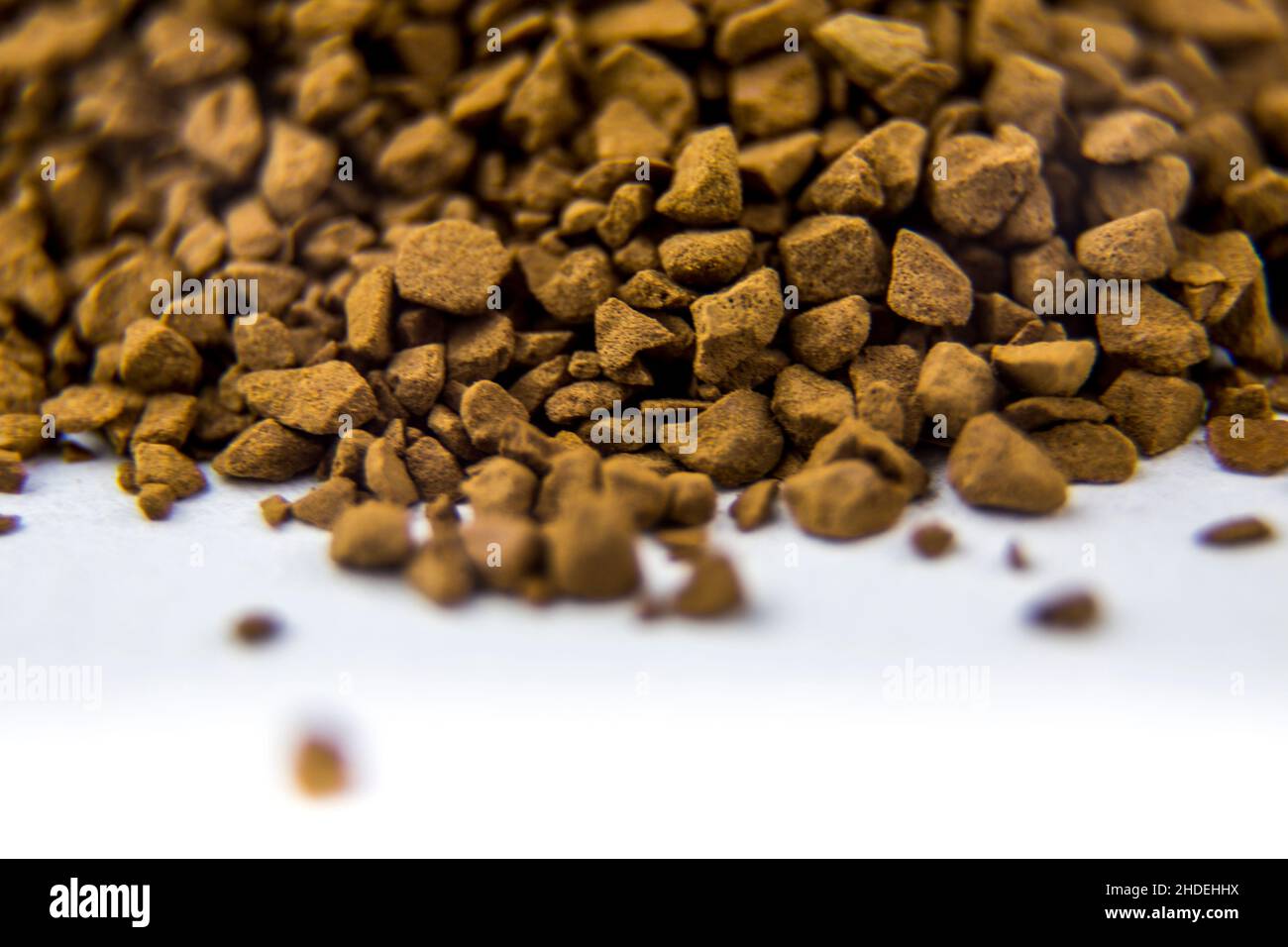 Instant coffee granules on a white background Stock Photo - Alamy