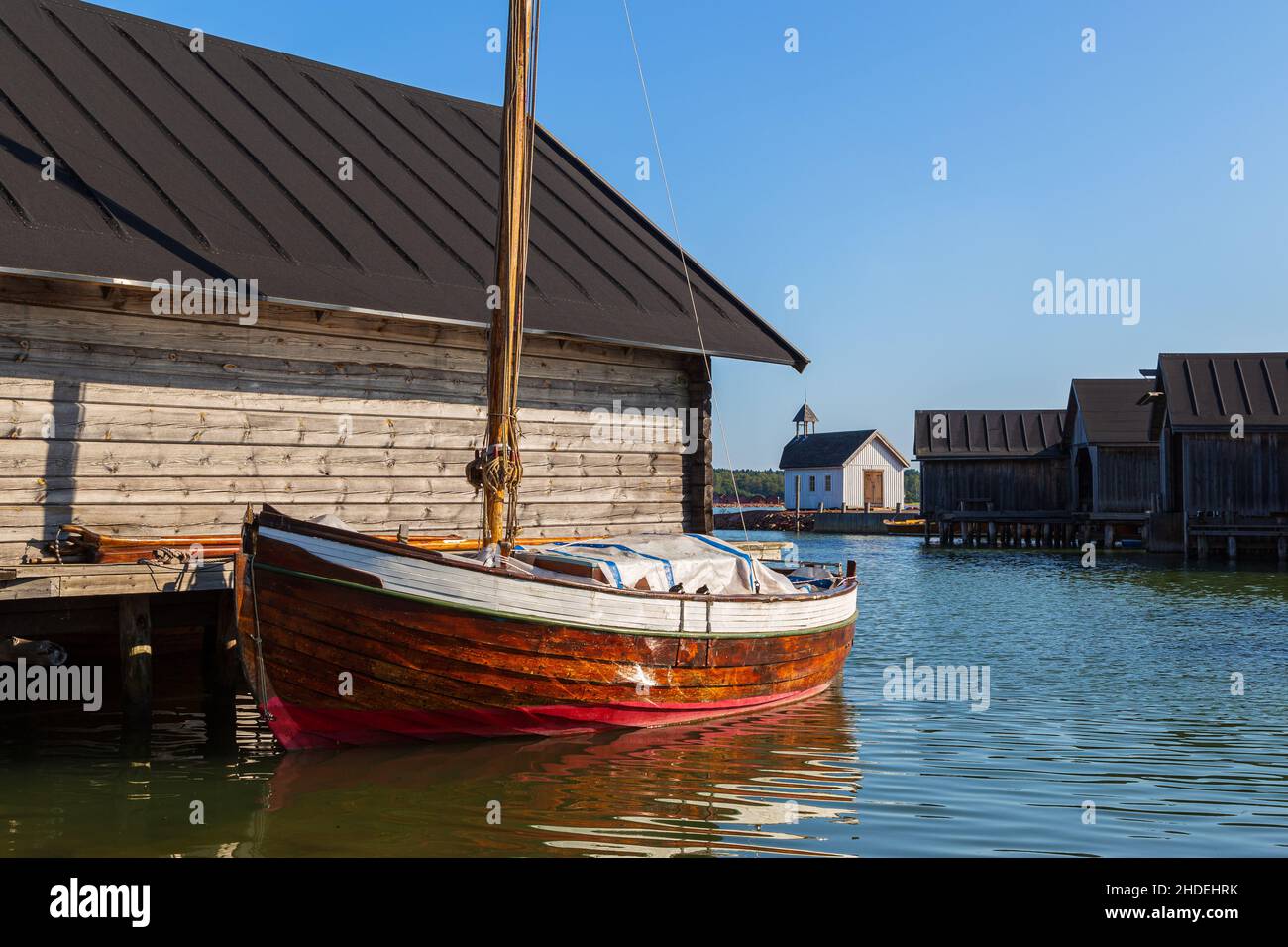 Old traditional wooden boathouses, an old sailing boat and Seafarer's ...