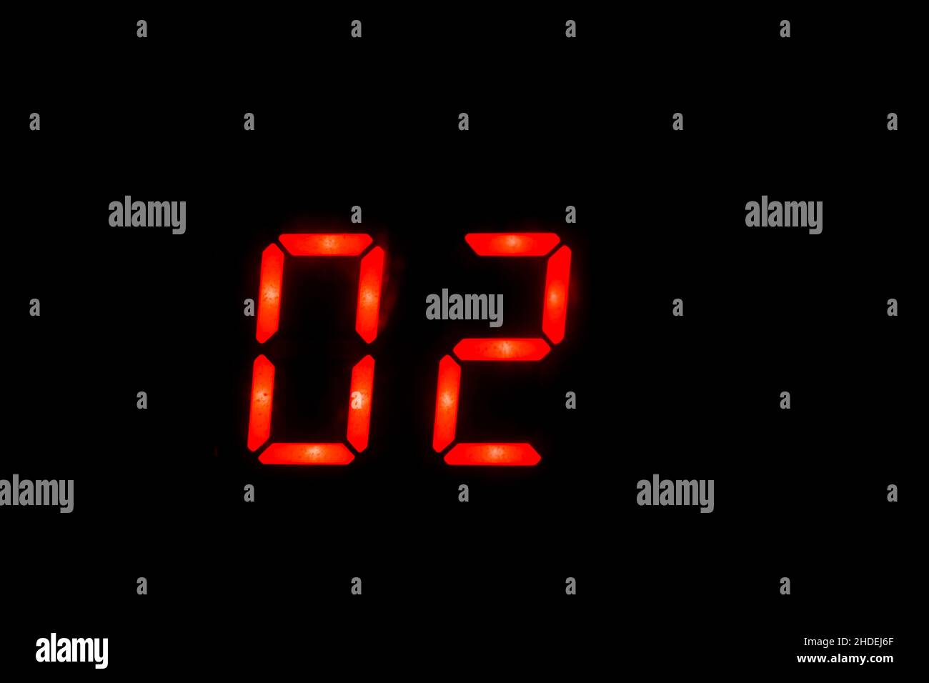 Old digital clock red number on black background Stock Photo - Alamy