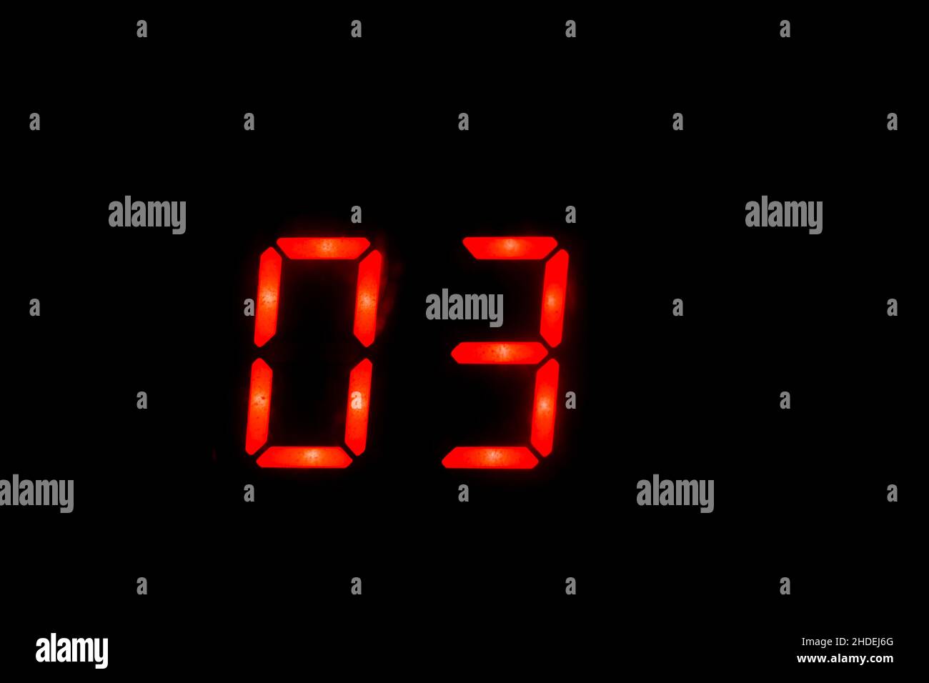 Old digital clock red number on black background Stock Photo - Alamy