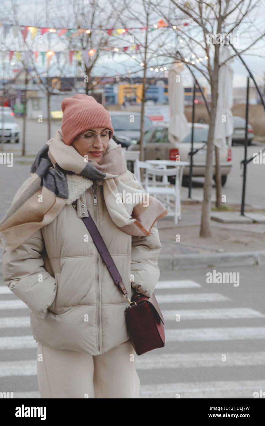 Beautiful baby boomer woman of middle age in glasses and stylish casual ...