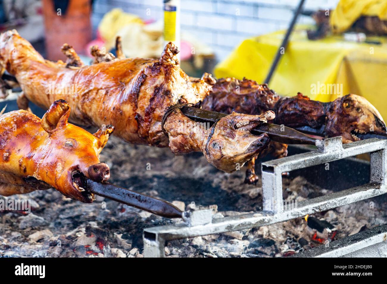 Whole pig roasting on a spit Stock Photo - Alamy
