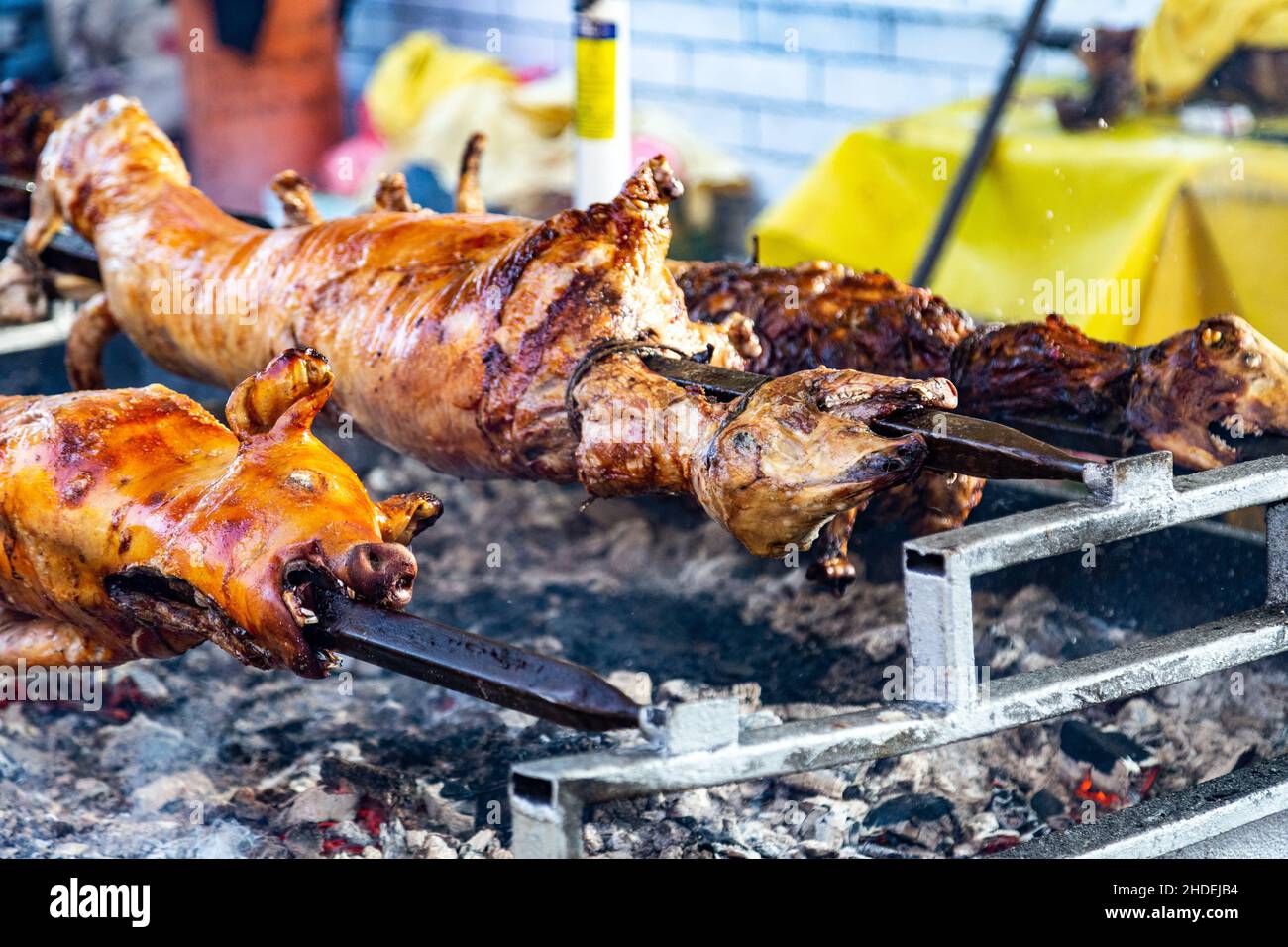 Whole pig roasting on a spit Stock Photo - Alamy