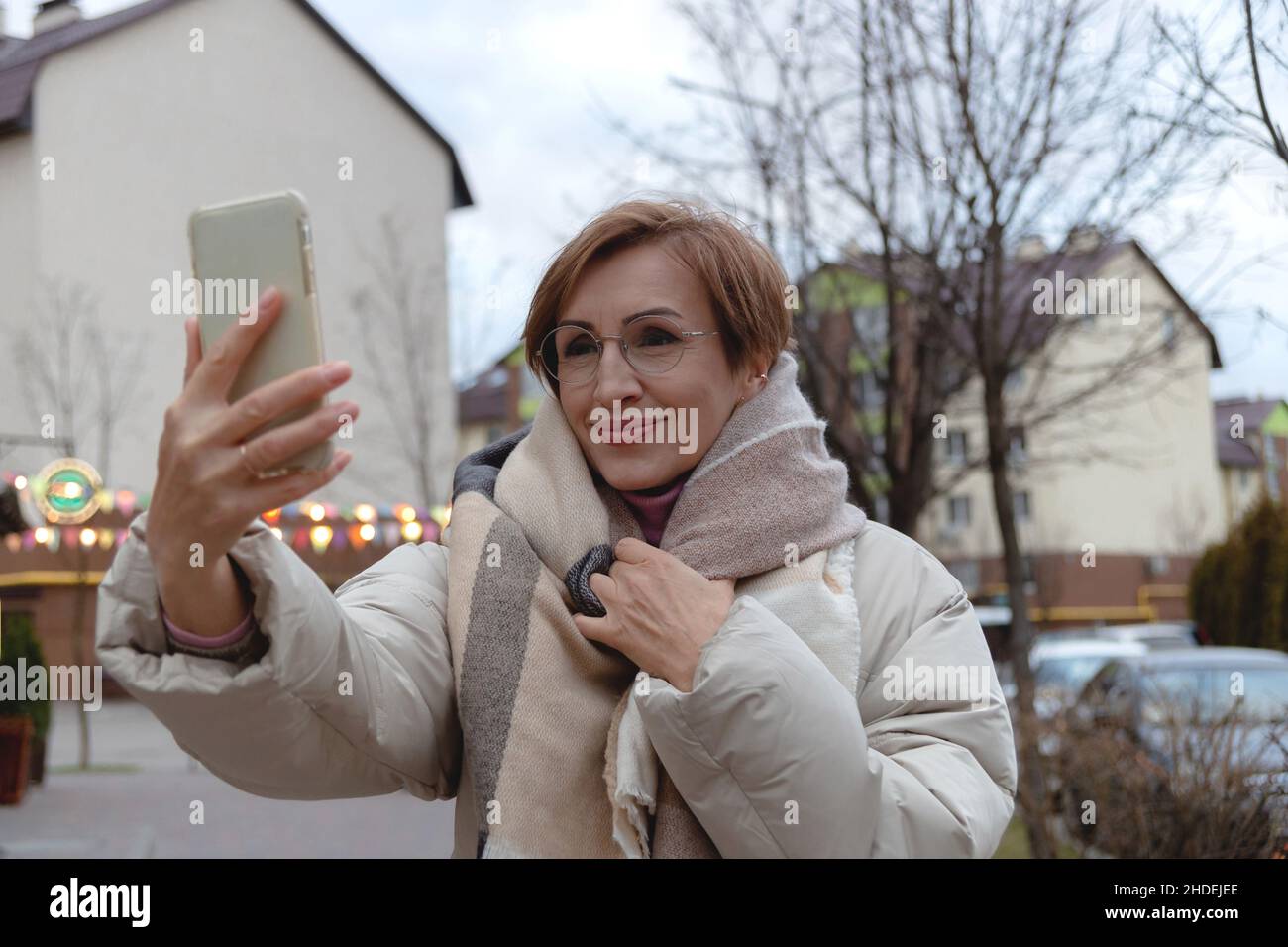 Beautiful baby boomer woman of middle age makes selfie on smartphone on ...